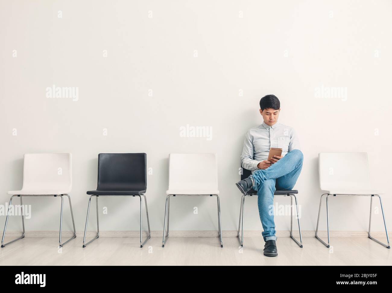 Asian man waiting for job interview indoors Stock Photo - Alamy