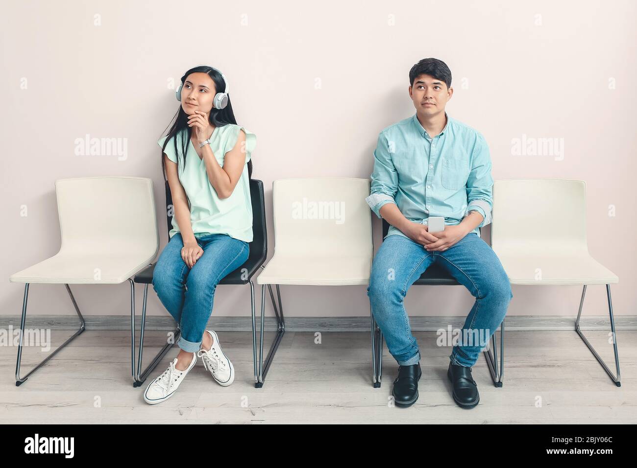 Young people waiting for job interview indoors Stock Photo - Alamy