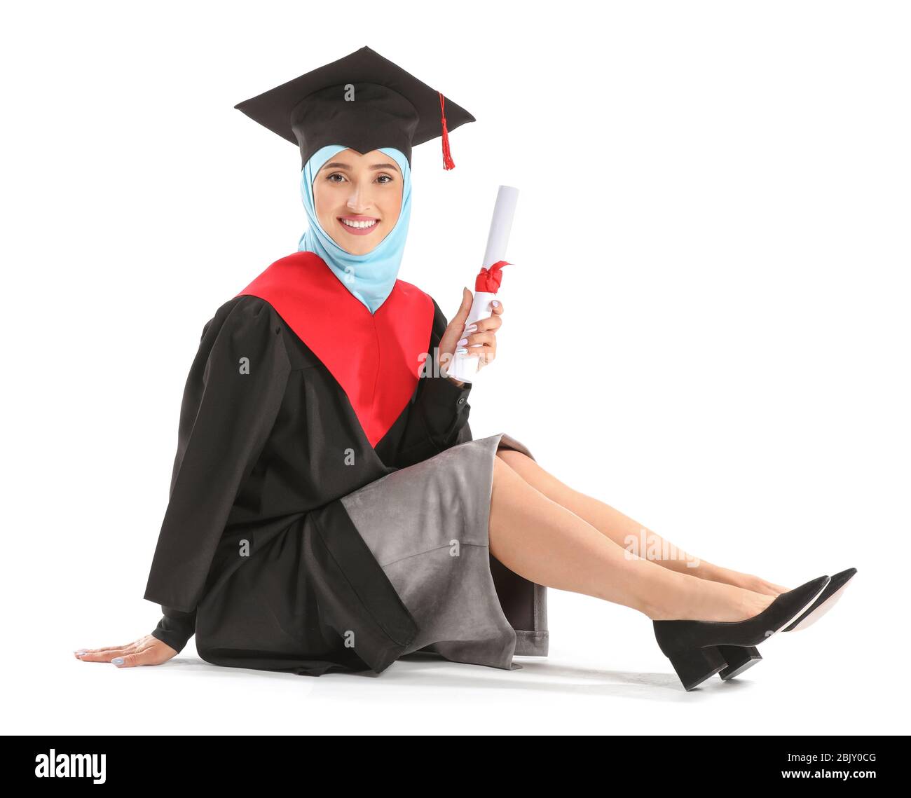 Muslim female graduate with diploma on white background Stock Photo - Alamy