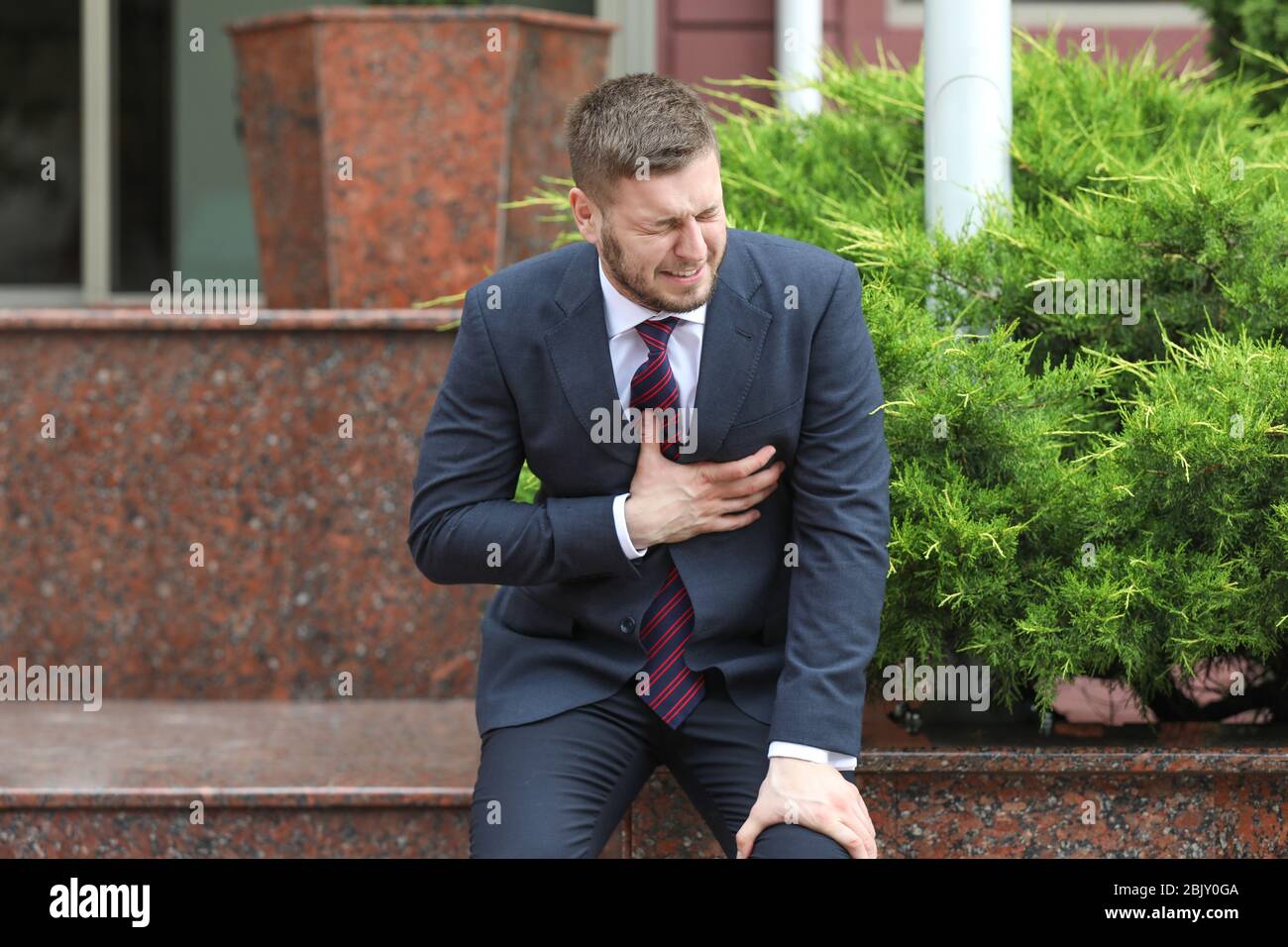 Businessman having panic attack outdoors Stock Photo - Alamy