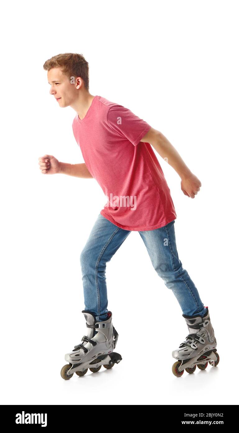 Teenage boy on roller skates against white background Stock Photo - Alamy