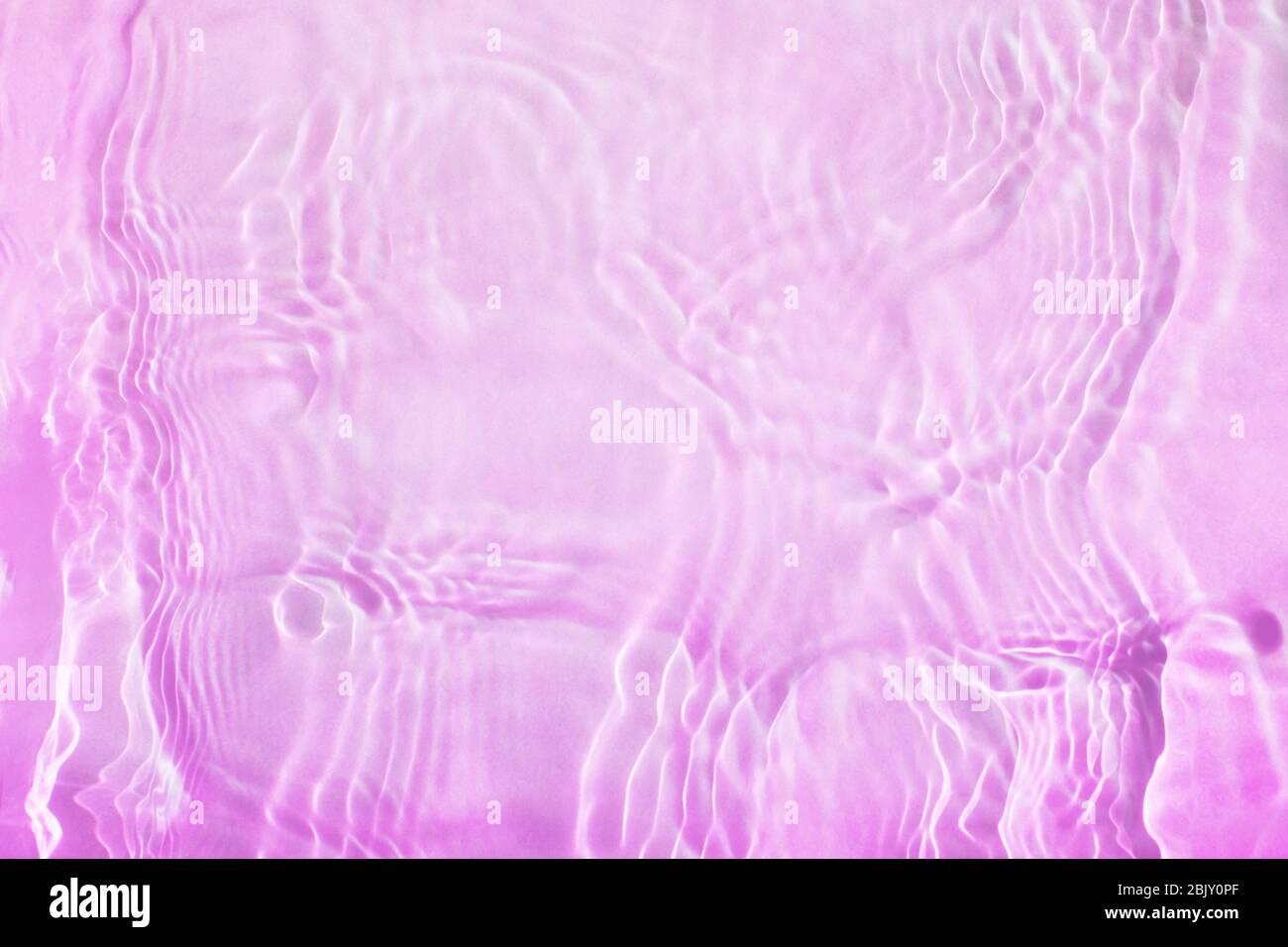 Abstract pink background of waves and ripples on the water Stock Photo ...