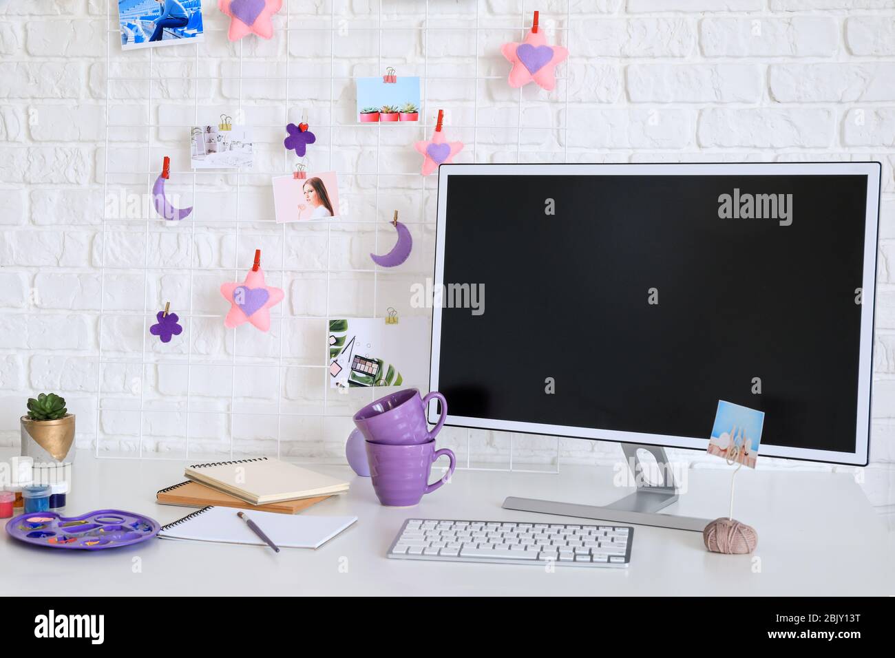 Workplace with mood board and computer in modern room Stock Photo - Alamy