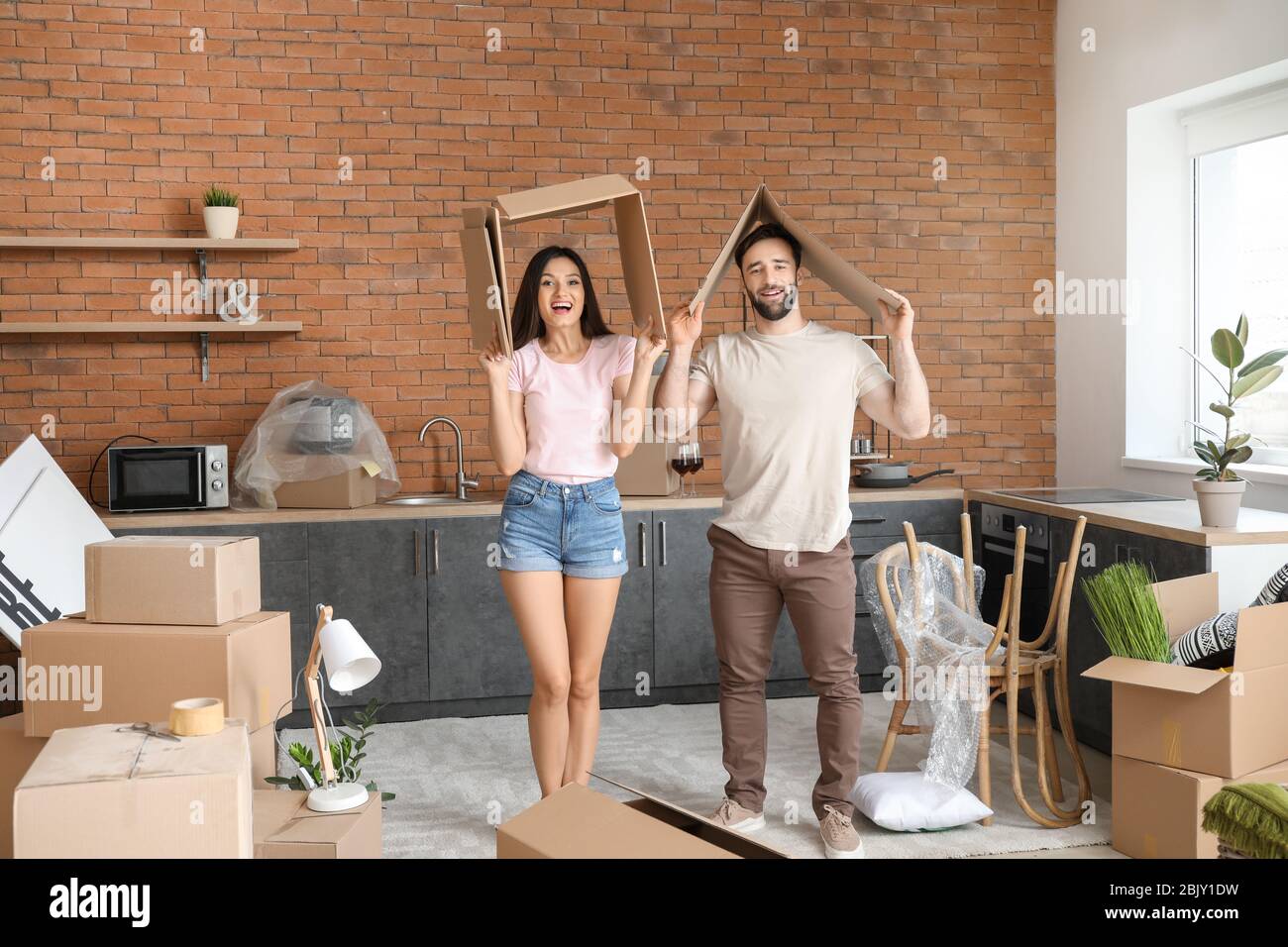 Happy young couple after moving into new house Stock Photo - Alamy