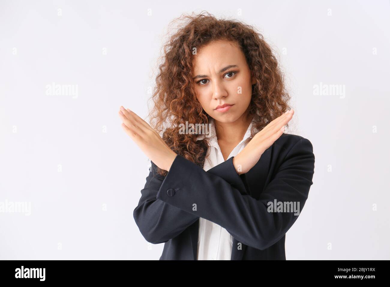 African-American businesswoman rejecting something on white background ...