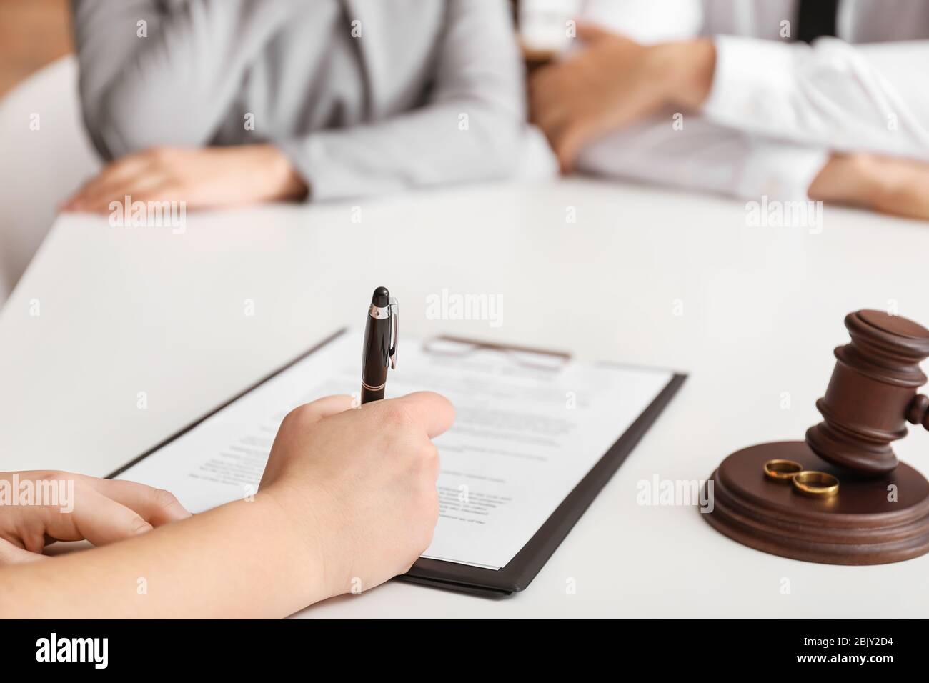 Lawyer signing document in office. Concept of divorce Stock Photo - Alamy