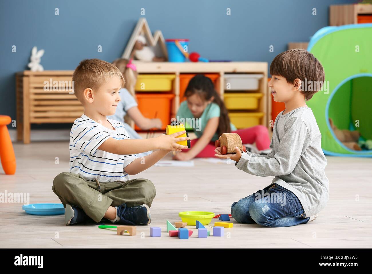 Cute little children playing in kindergarten Stock Photo - Alamy