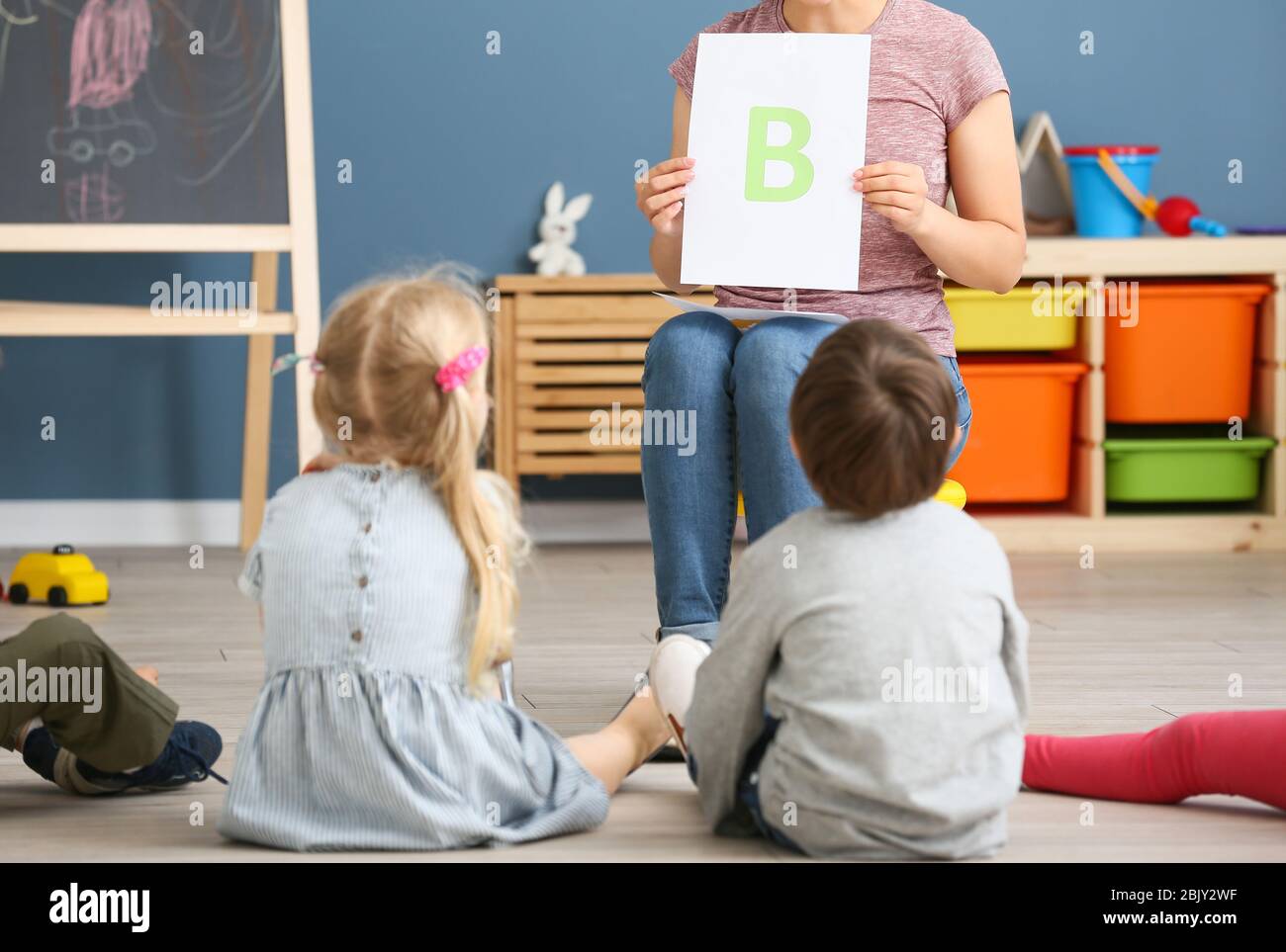 Cute little children learning letters in kindergarten Stock Photo - Alamy