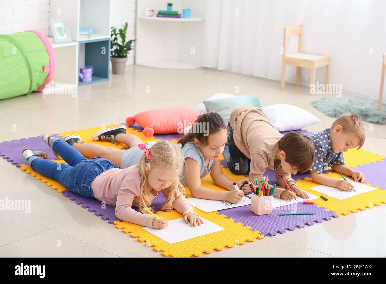 Cute little children drawing in kindergarten Stock Photo - Alamy