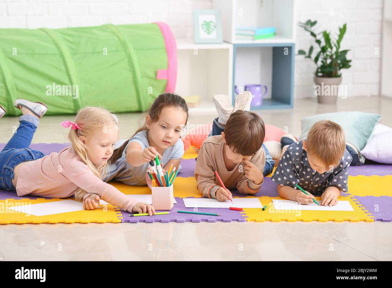 Cute little children drawing in kindergarten Stock Photo - Alamy