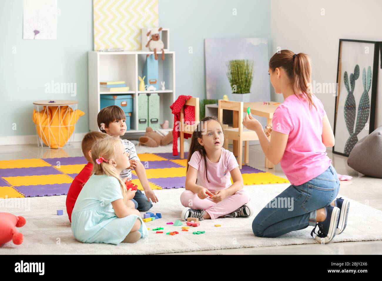 Cute little children learning letters in kindergarten Stock Photo - Alamy