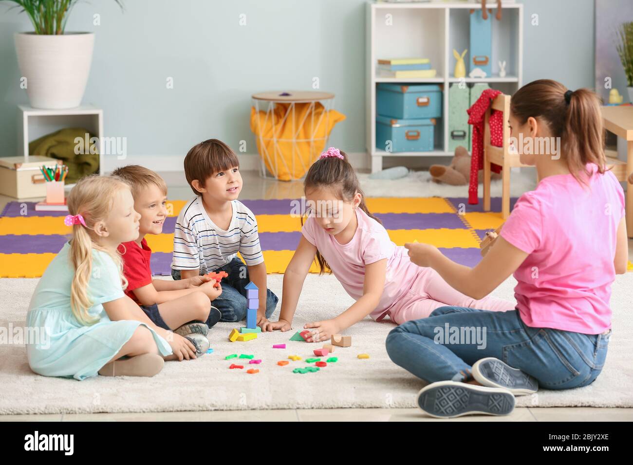 Cute little children learning letters in kindergarten Stock Photo - Alamy