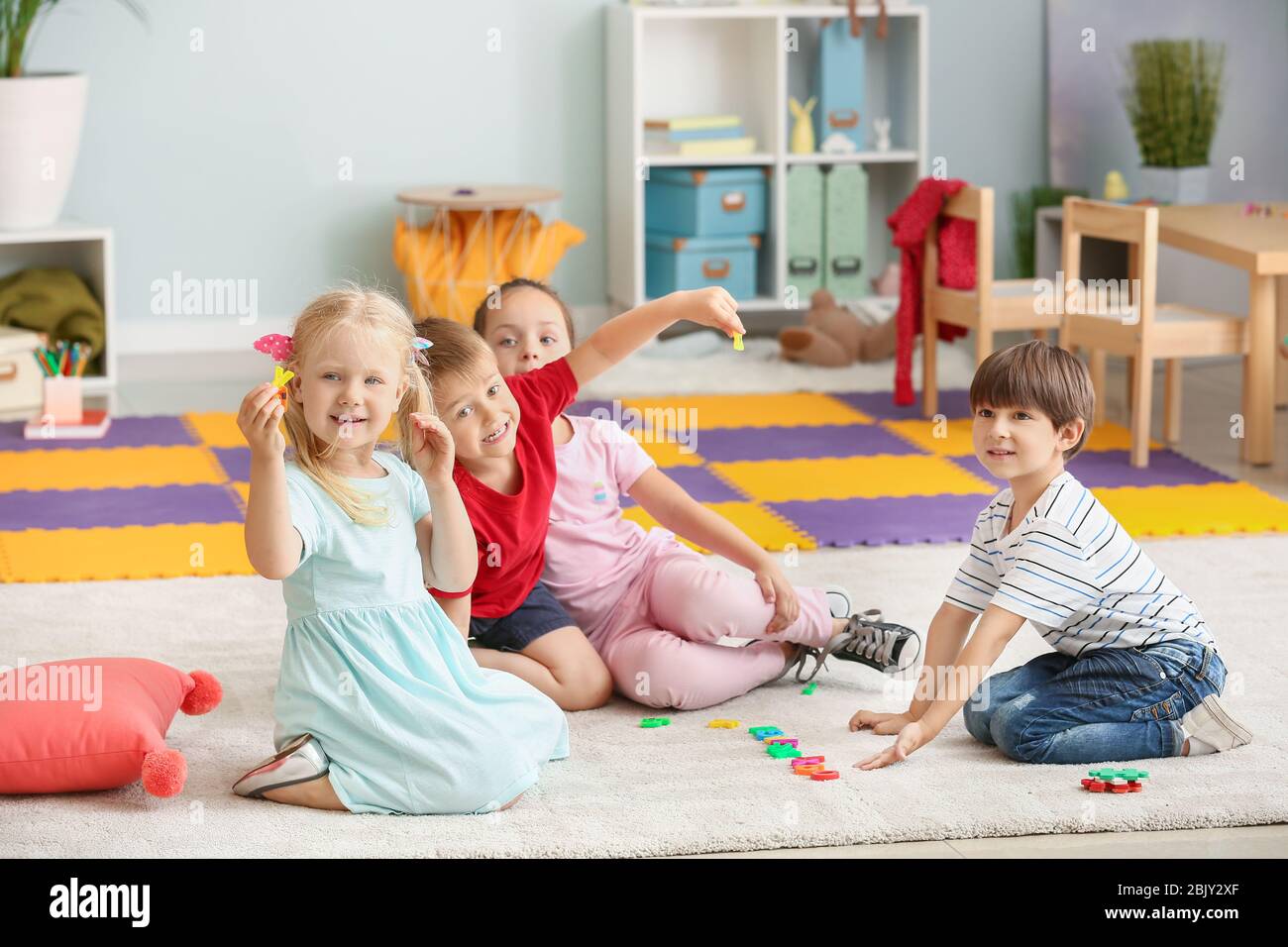 Cute little children playing in kindergarten Stock Photo - Alamy