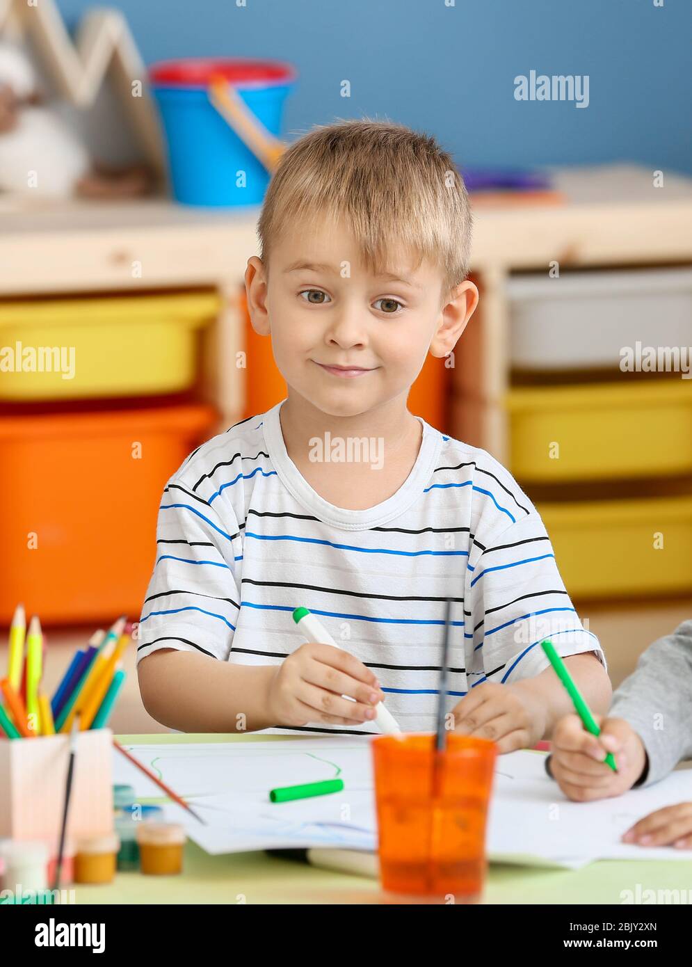Cute little children drawing in kindergarten Stock Photo - Alamy