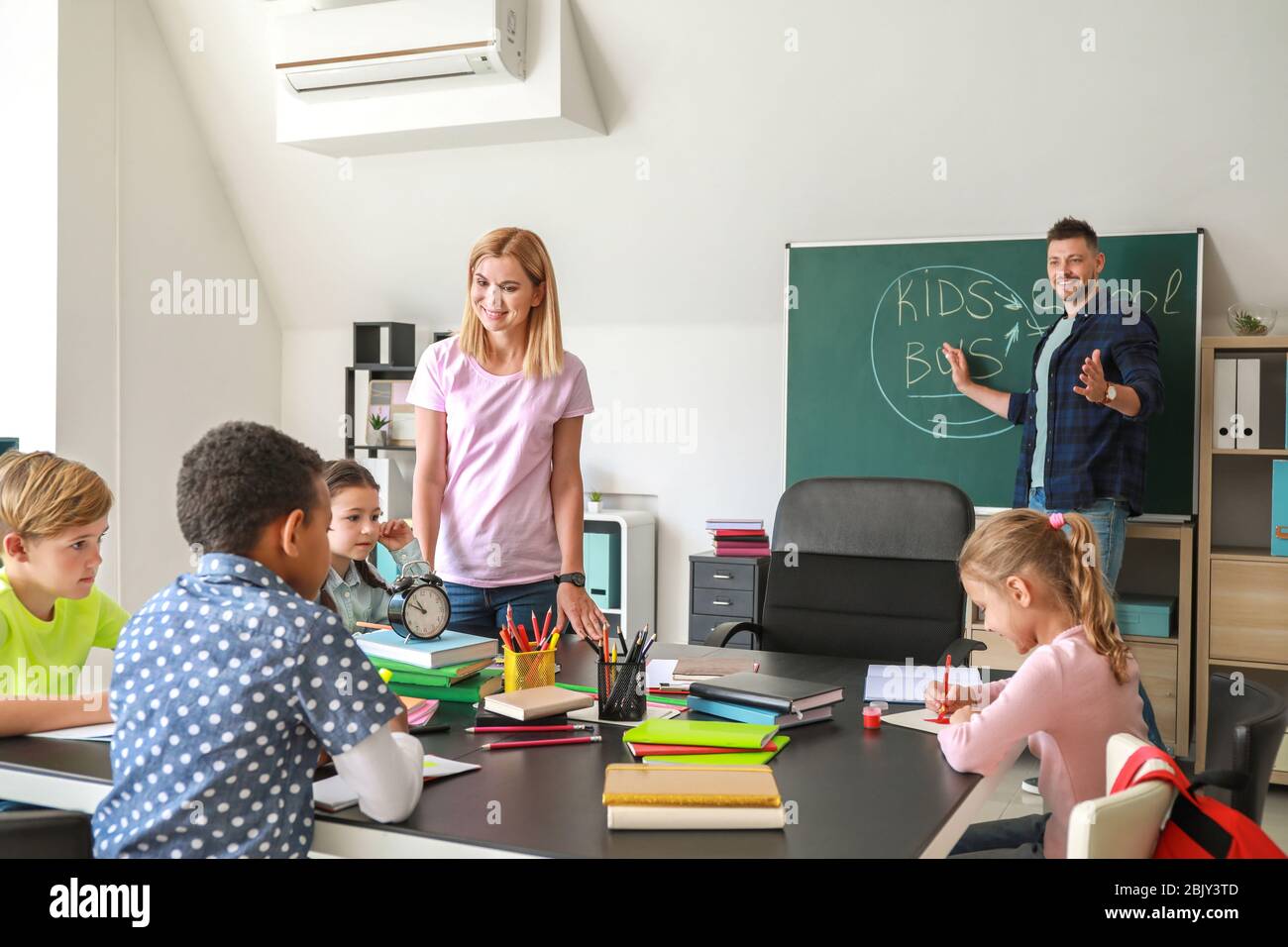 Teachers conducting lesson in classroom Stock Photo - Alamy