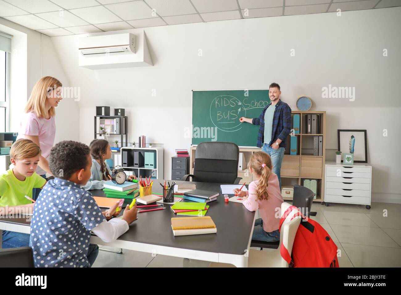 Teachers conducting lesson in classroom Stock Photo - Alamy