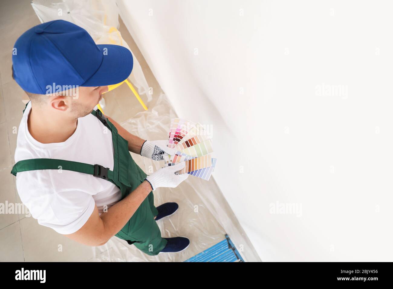 Male painter with color samples in room Stock Photo - Alamy