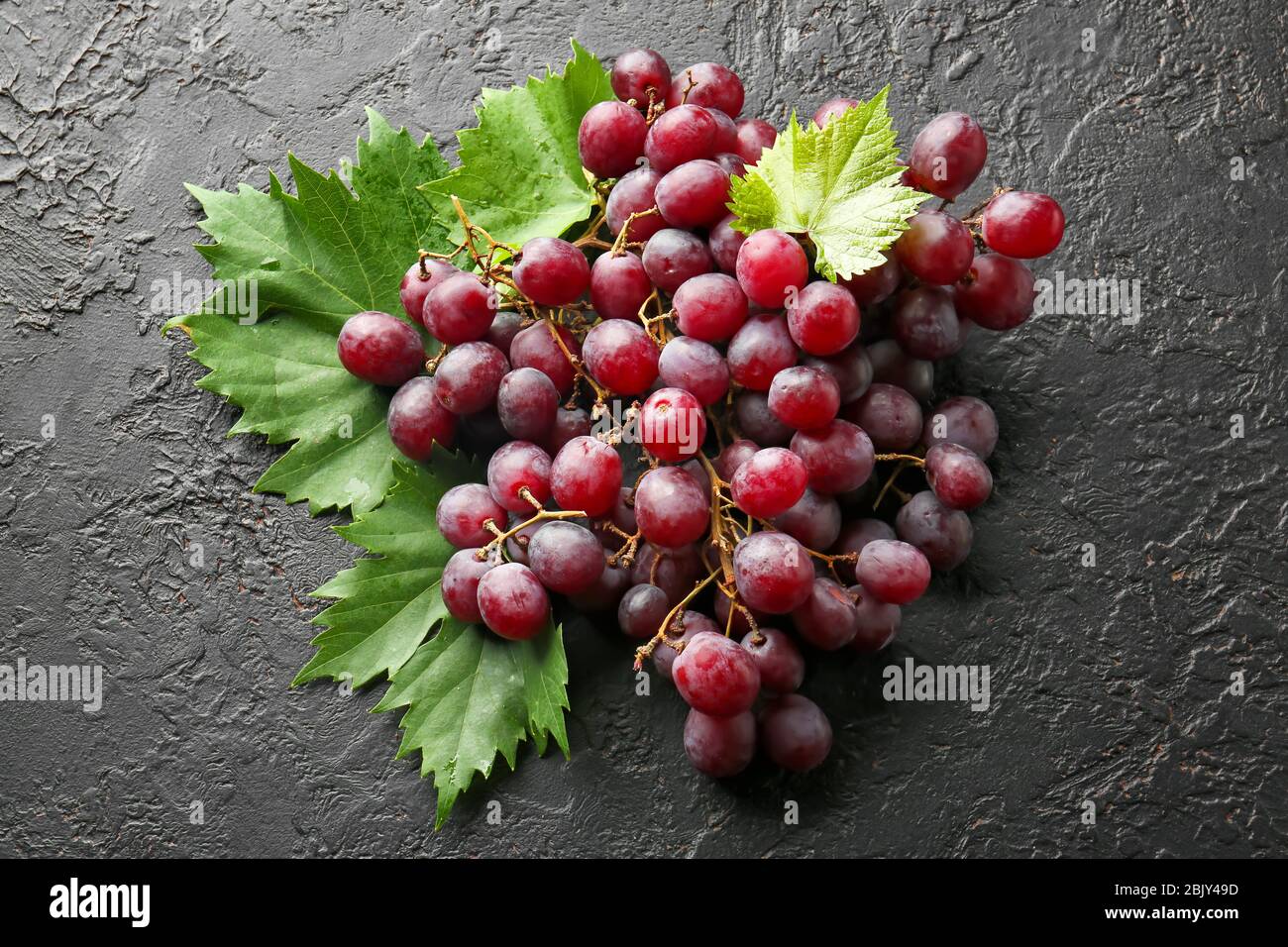 Ripe sweet grapes on dark background Stock Photo - Alamy