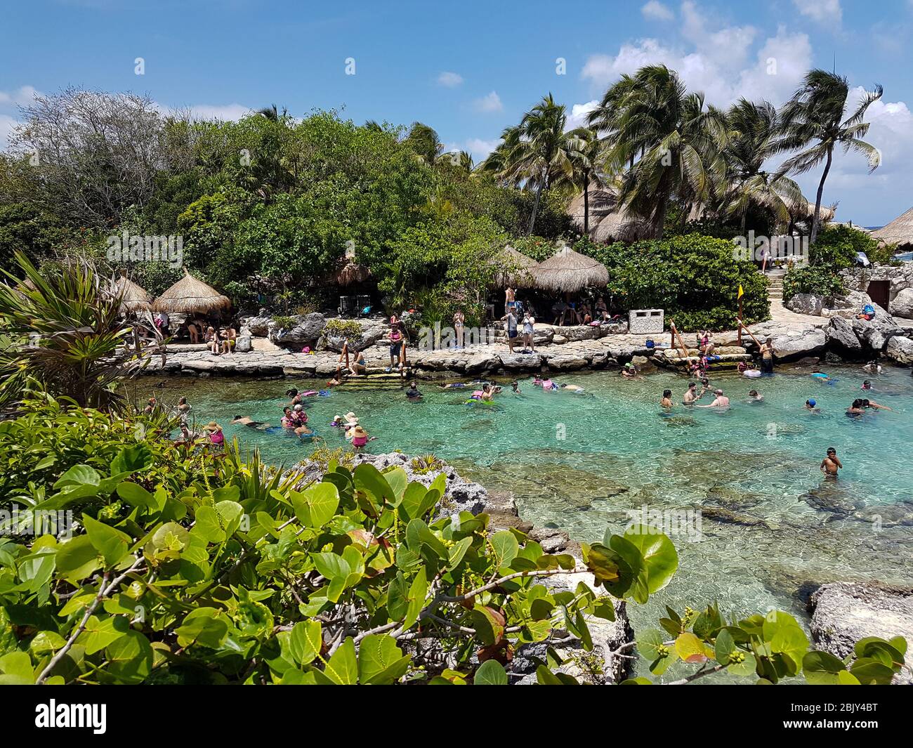tropical pool bar with families enjoying their vacation at a Caribbean ...