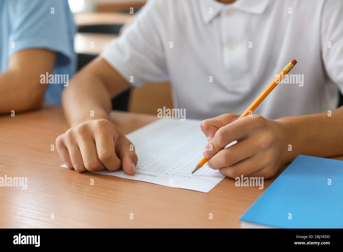 Teenage boy passing school test in classroom Stock Photo - Alamy