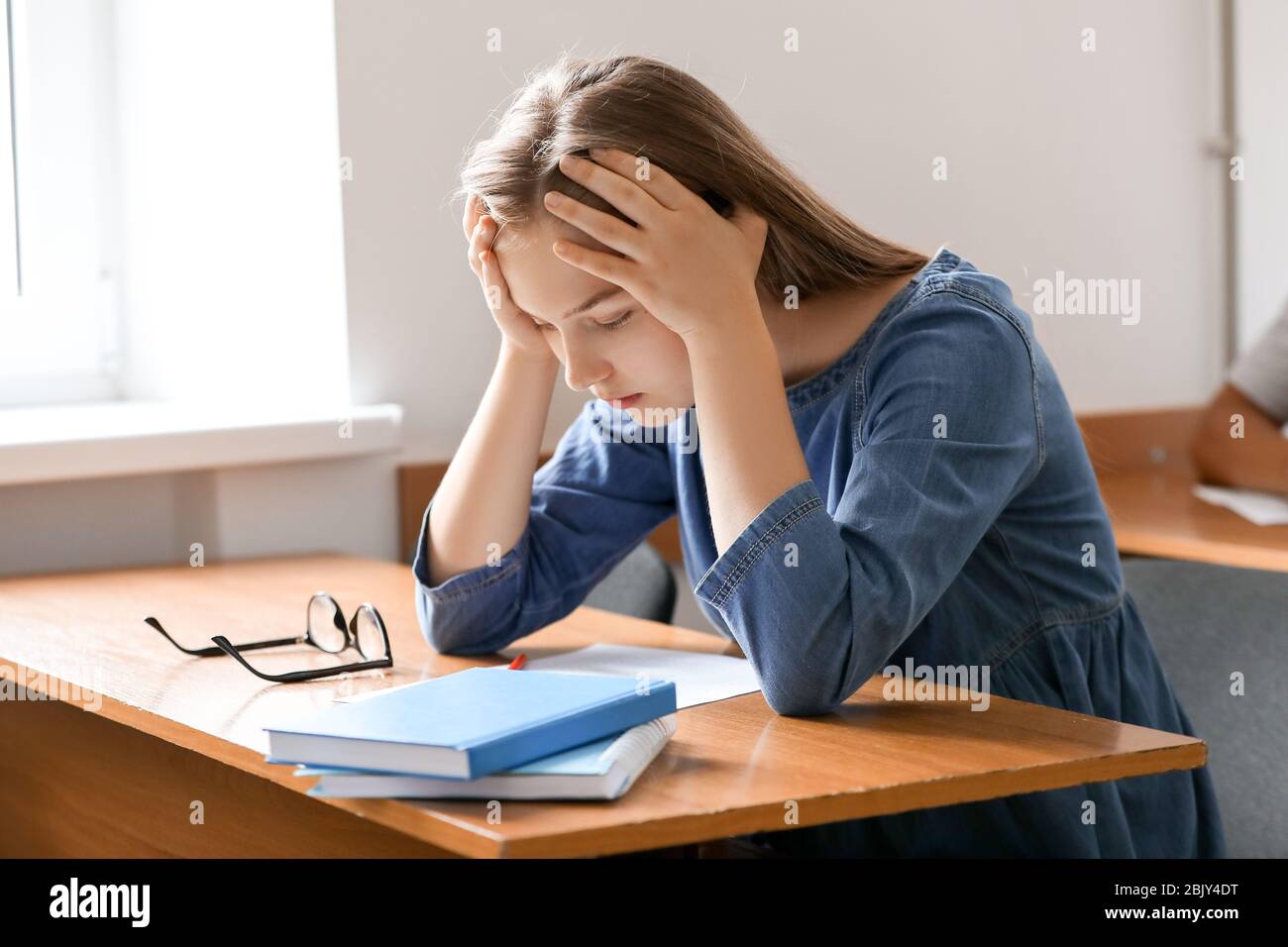 Teenage girl passing school test in classroom Stock Photo - Alamy
