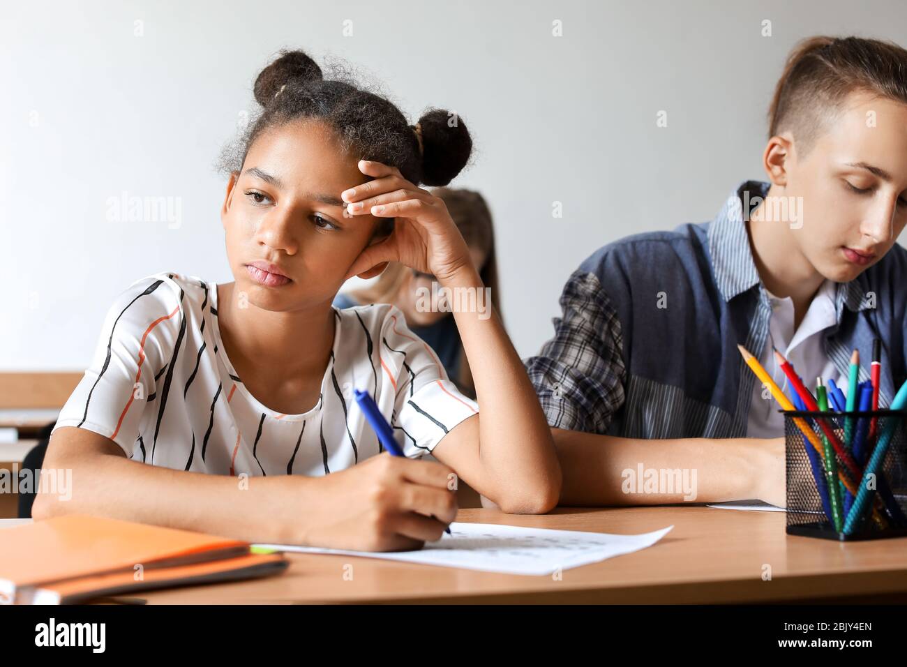 Pupils passing school test in classroom Stock Photo - Alamy