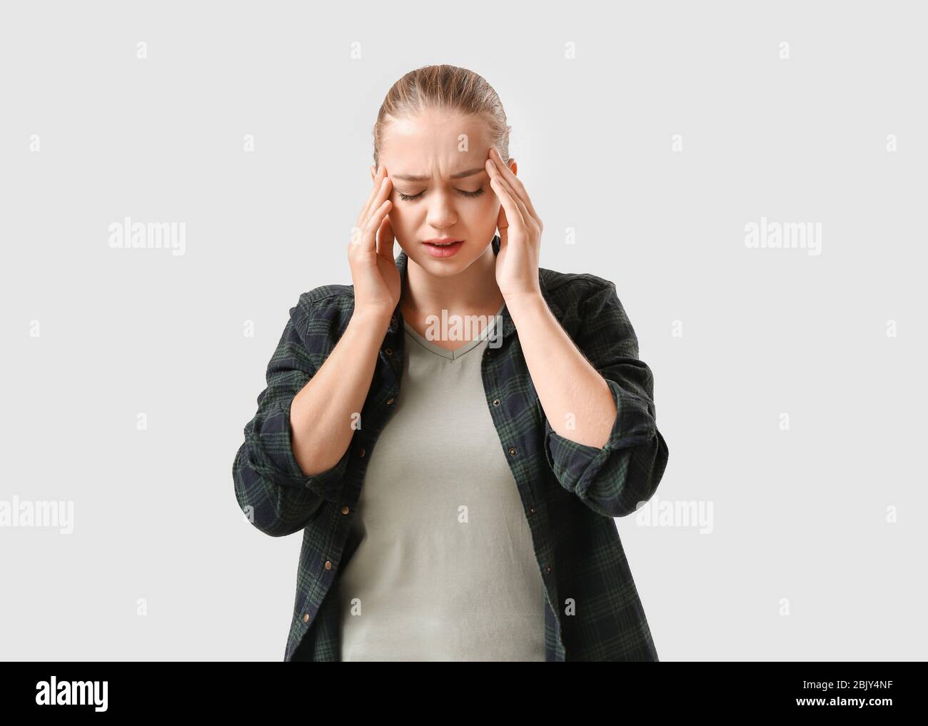 Woman having panic attack on light background Stock Photo - Alamy