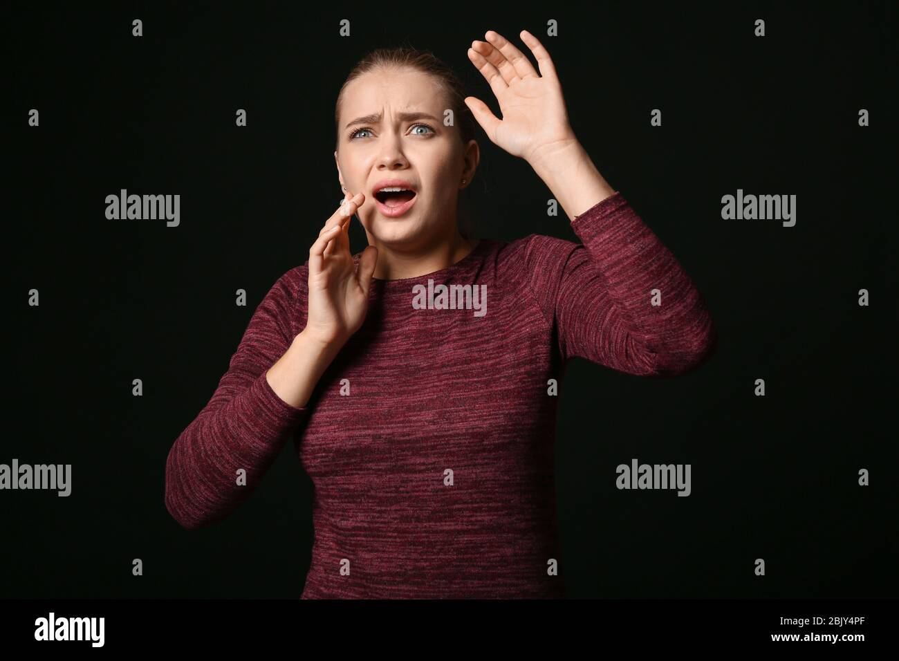 Woman having panic attack on dark background Stock Photo - Alamy