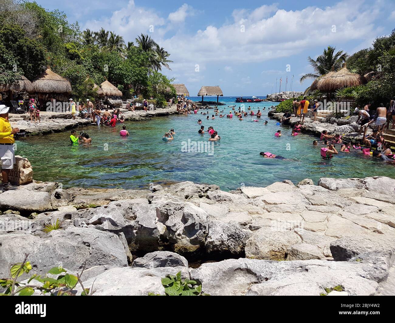 tropical pool bar with families enjoying their vacation at a Caribbean ...