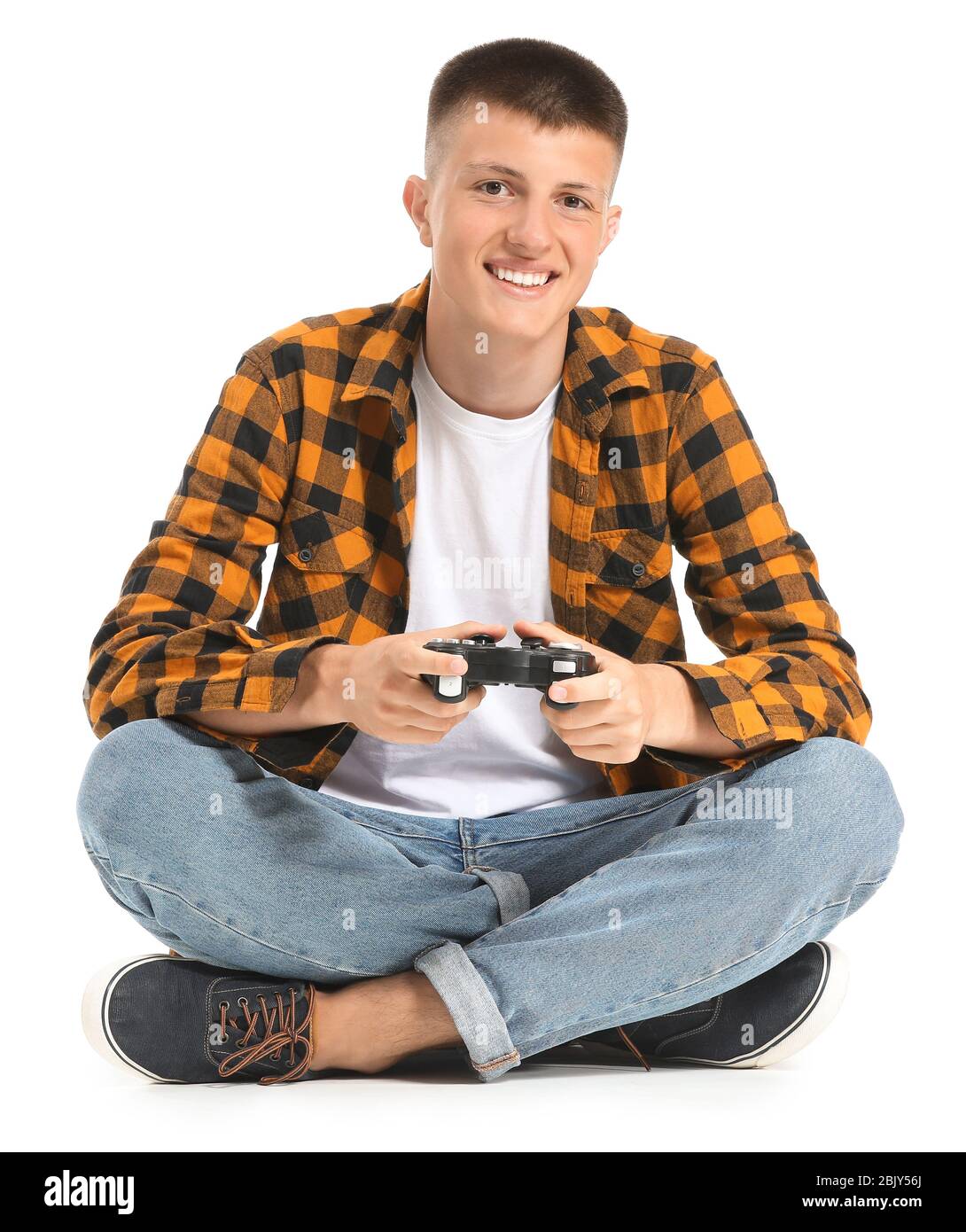Teenage boy playing video game on white background Stock Photo - Alamy