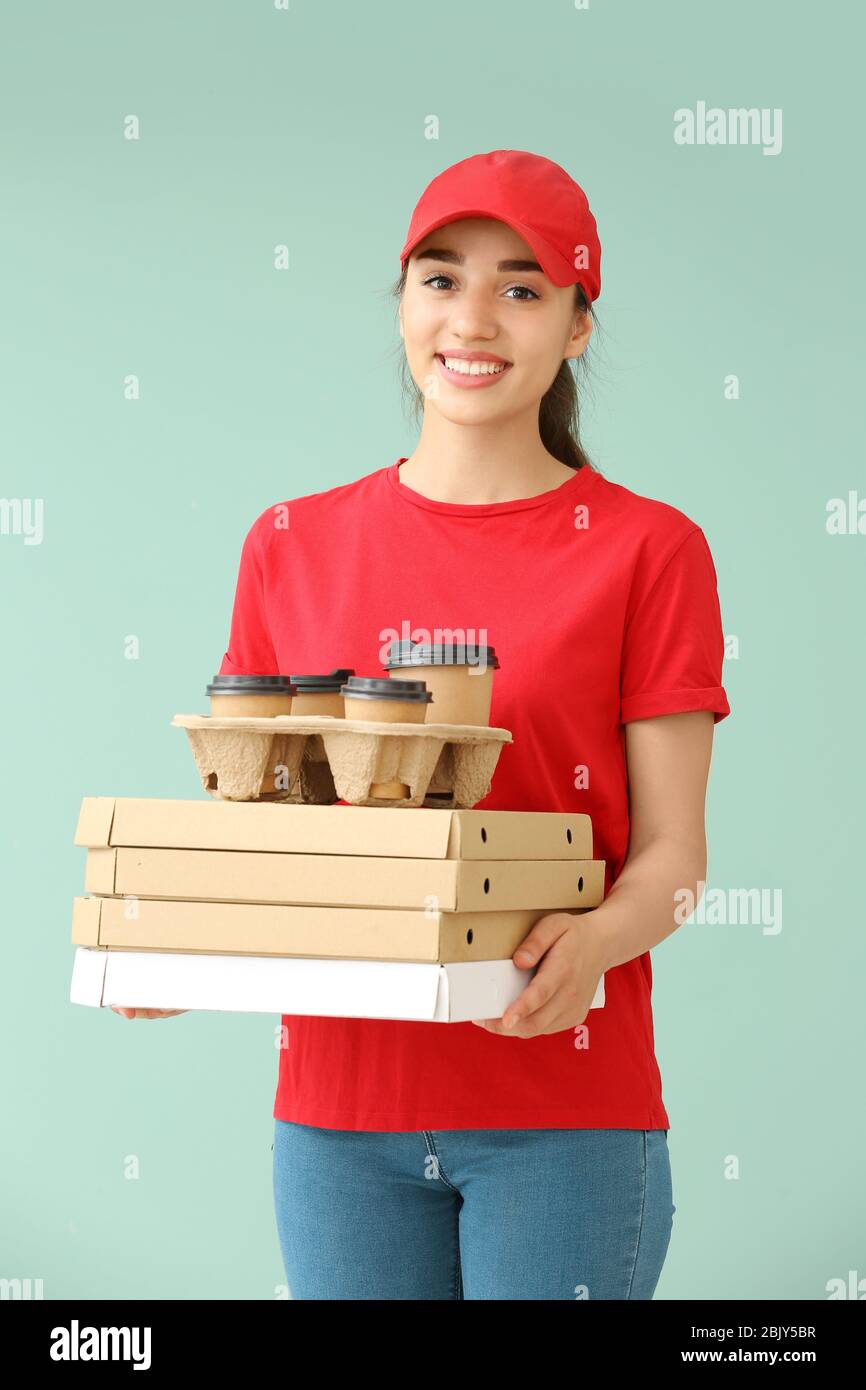 Female worker of food delivery service on color background Stock Photo ...