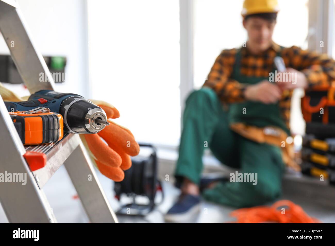 Electrician's tools on ladder in room, closeup Stock Photo - Alamy