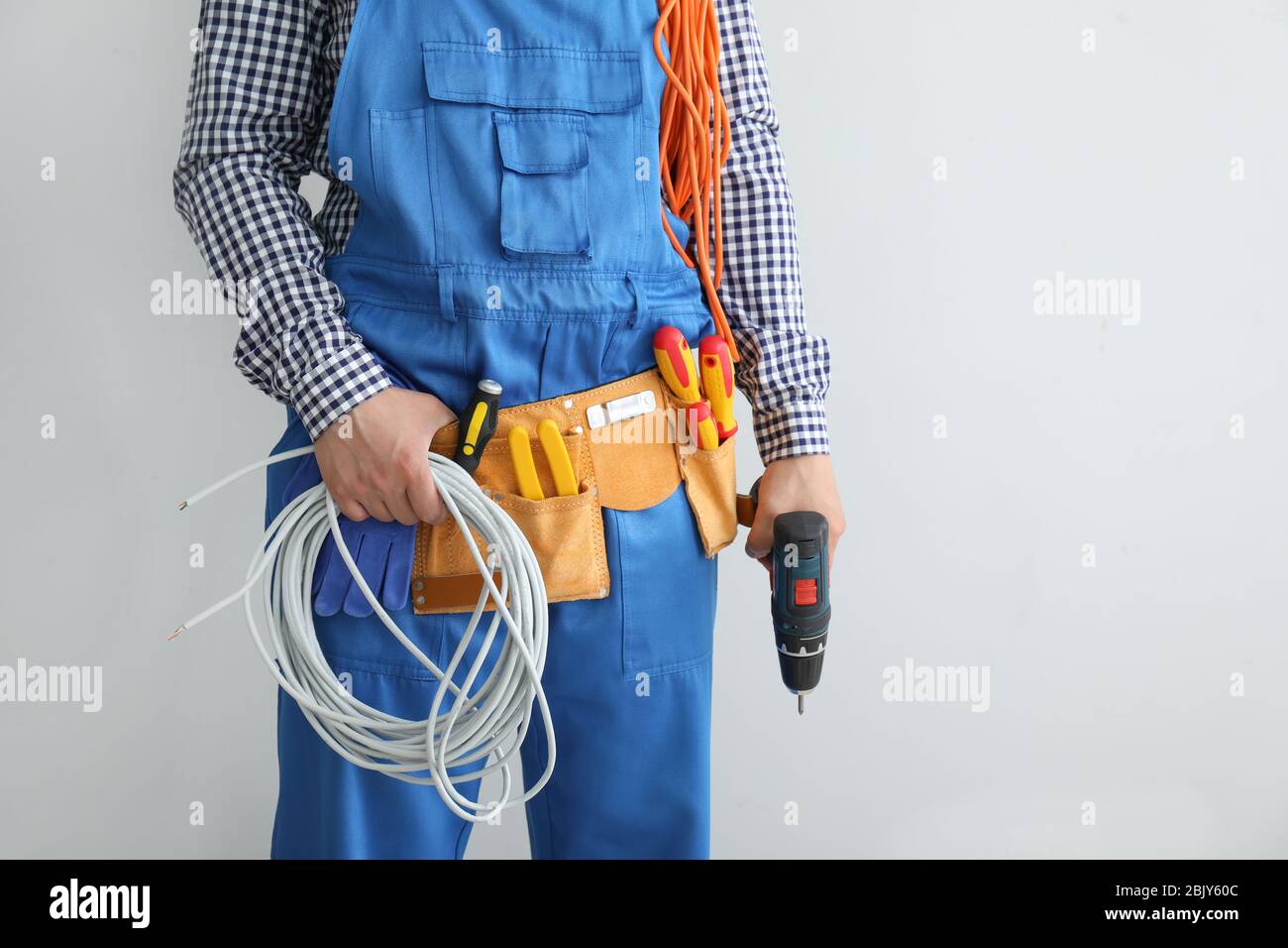 Male electrician on white background Stock Photo - Alamy
