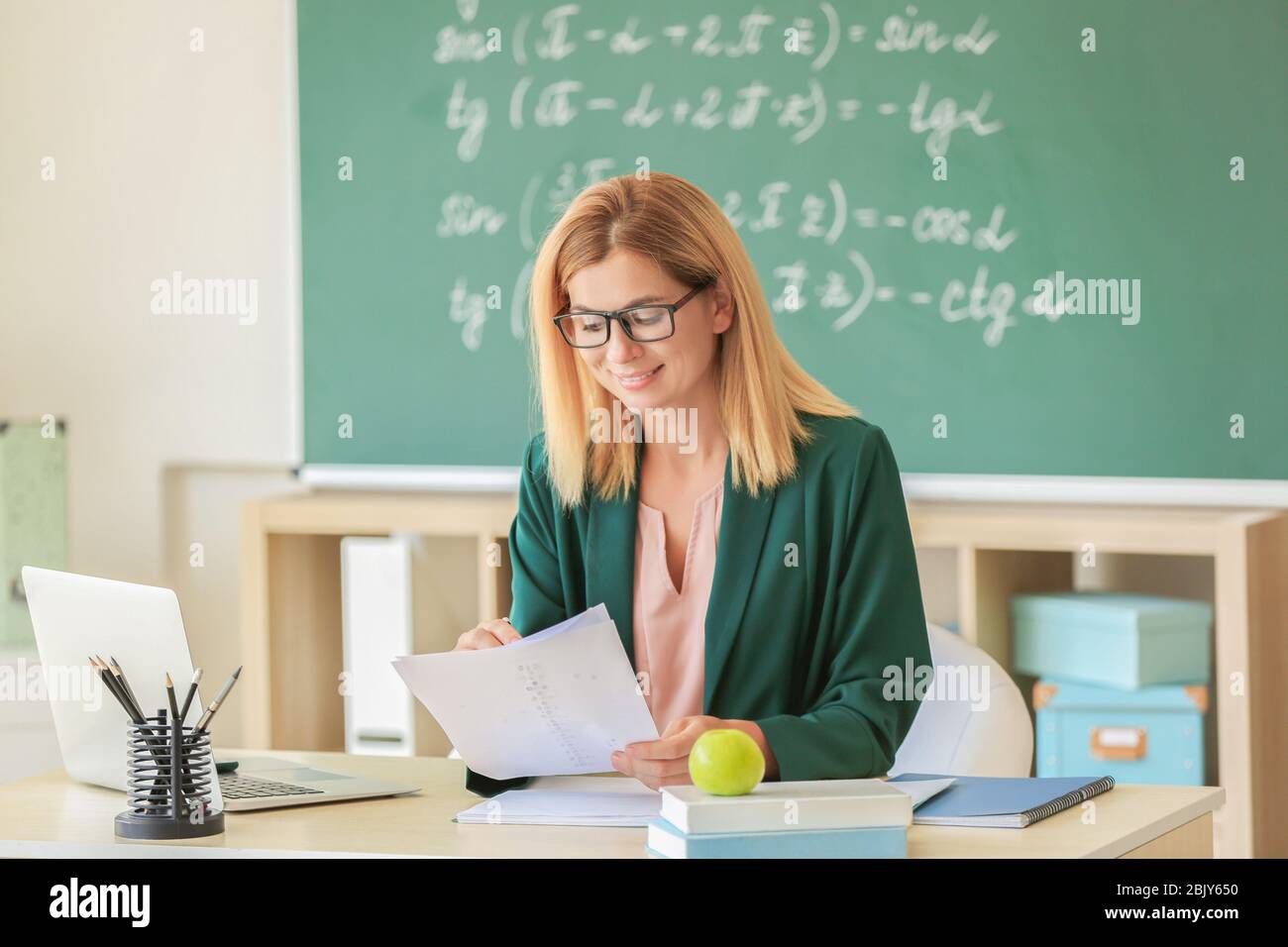 Beautiful female teacher in classroom Stock Photo - Alamy