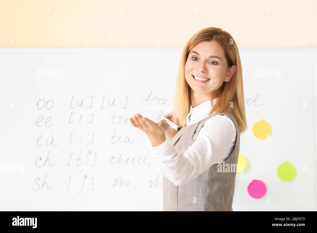 Beautiful English teacher calling out pupil during lesson in classroom ...