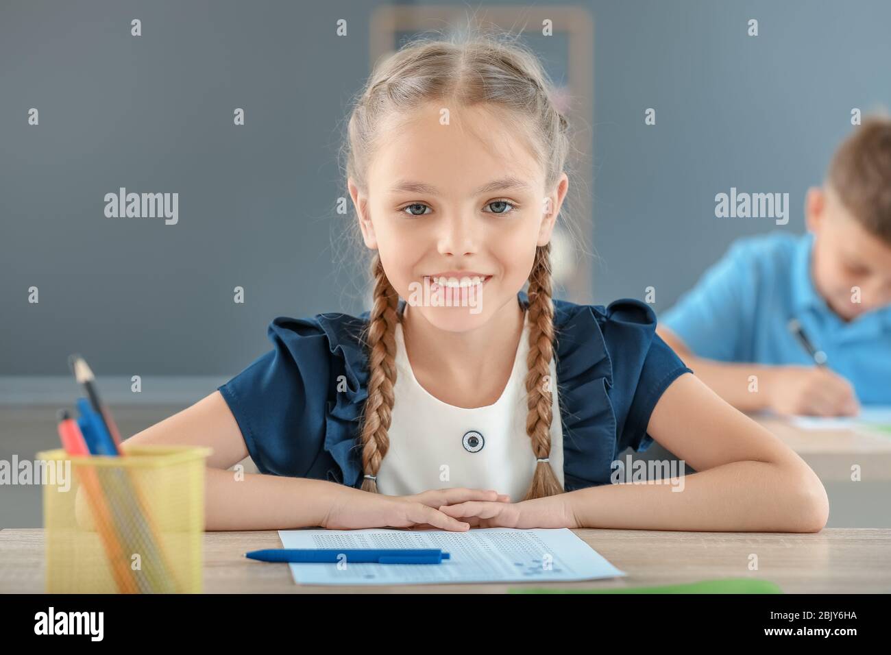 Pupil passing school test in classroom Stock Photo - Alamy
