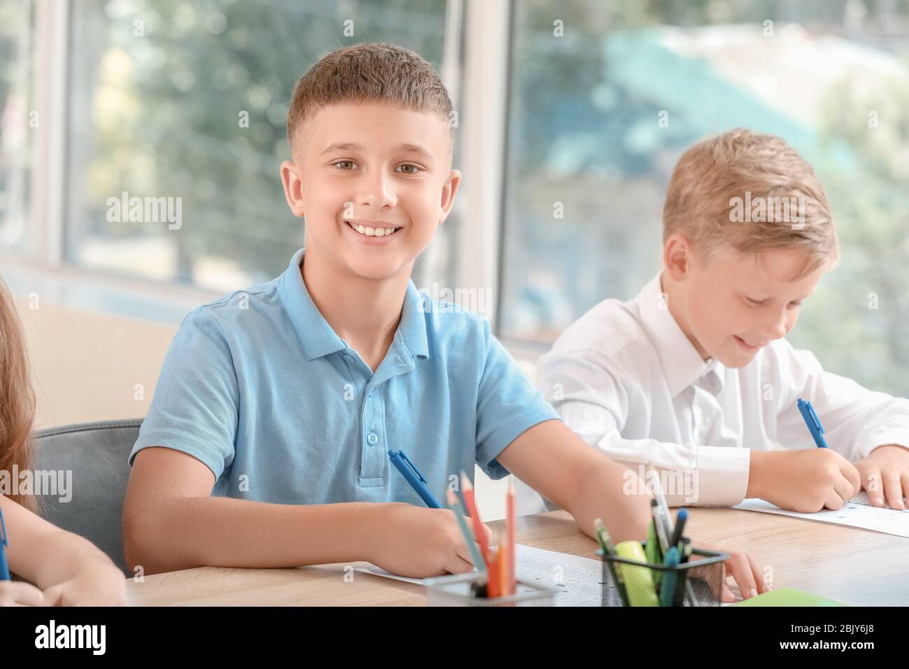Pupils passing school test in classroom Stock Photo - Alamy