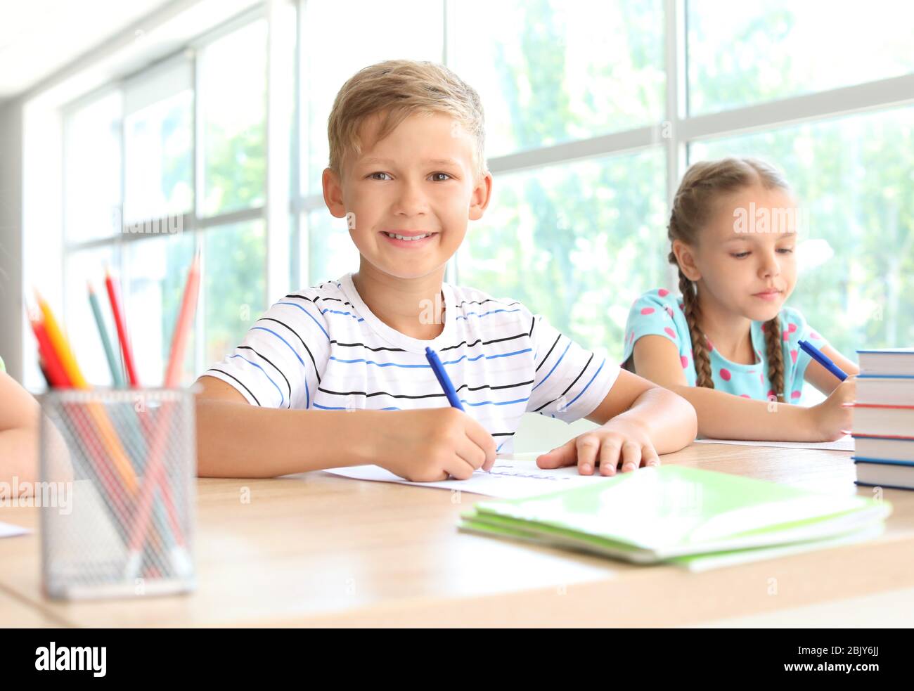 Pupils passing school test in classroom Stock Photo - Alamy