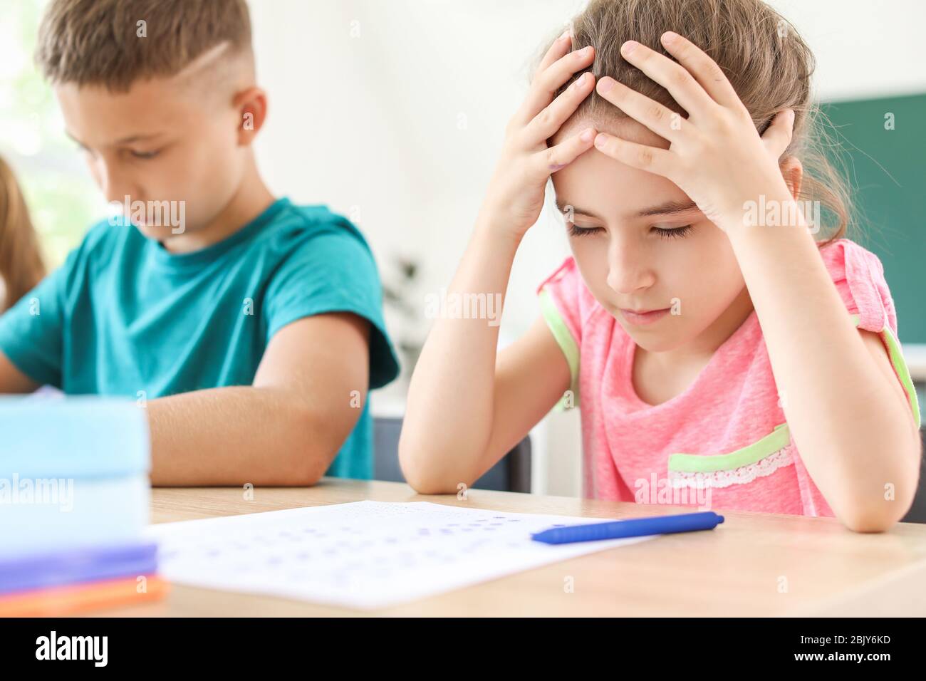 Child writing classroom sad hi-res stock photography and images - Alamy