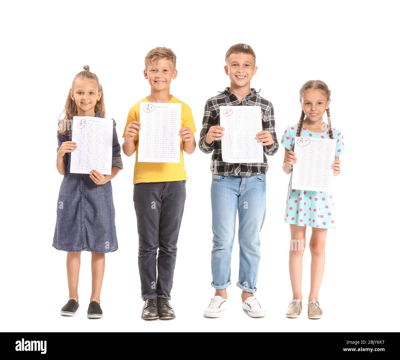 Happy children with answer sheets for school test on white background ...