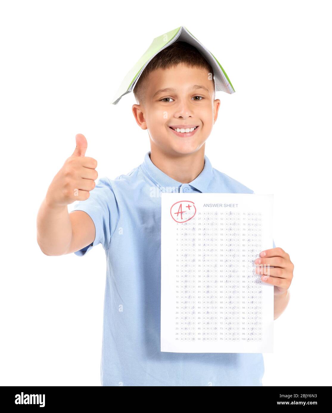 Happy boy with answer sheet for school test on white background Stock ...