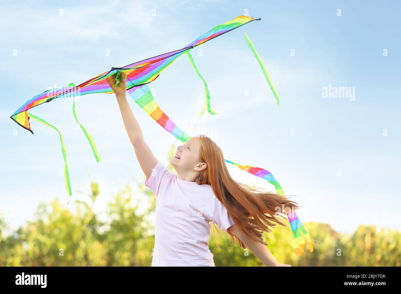 Little girl flying kite outdoors Stock Photo - Alamy