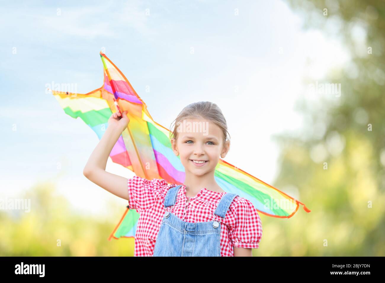 Little girl flying kite outdoors Stock Photo - Alamy