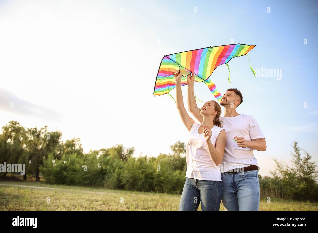 Young couple flying kite outdoors Stock Photo - Alamy