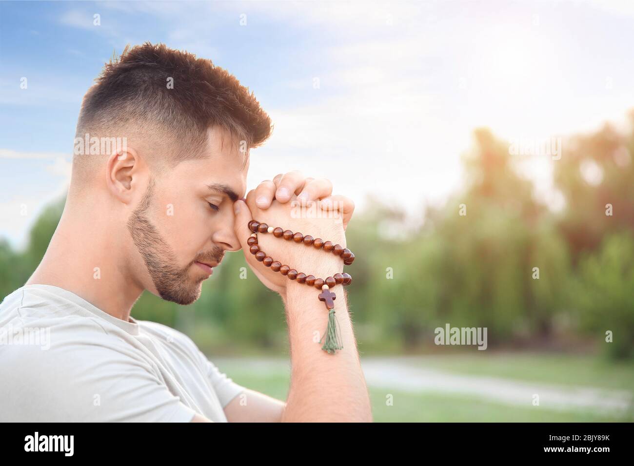Young man praying to God outdoors Stock Photo - Alamy