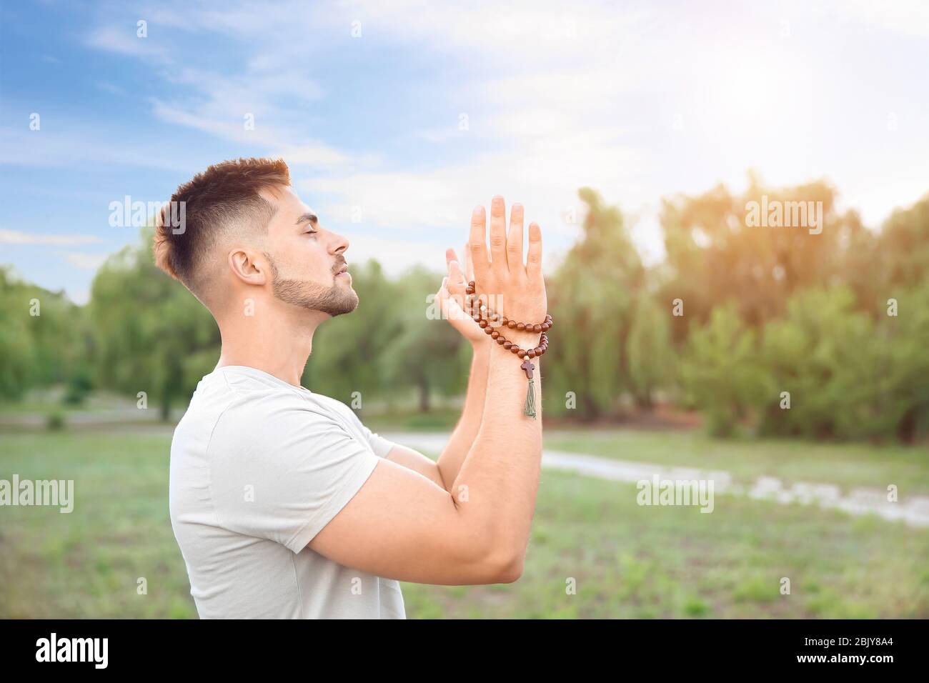 Young man praying to God outdoors Stock Photo - Alamy