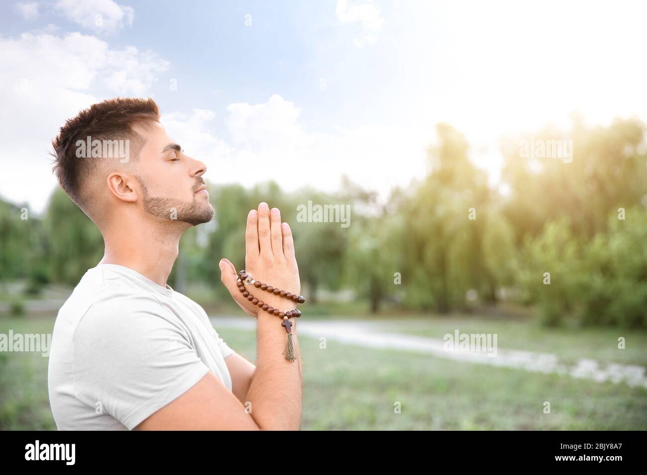 Young man praying to God outdoors Stock Photo - Alamy