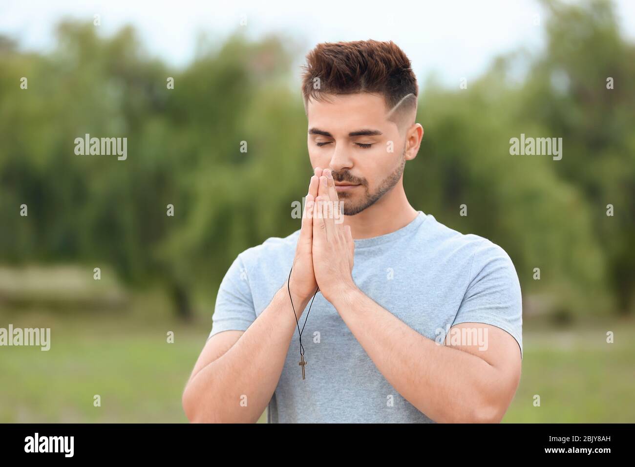 Young man begging praying hi-res stock photography and images - Alamy
