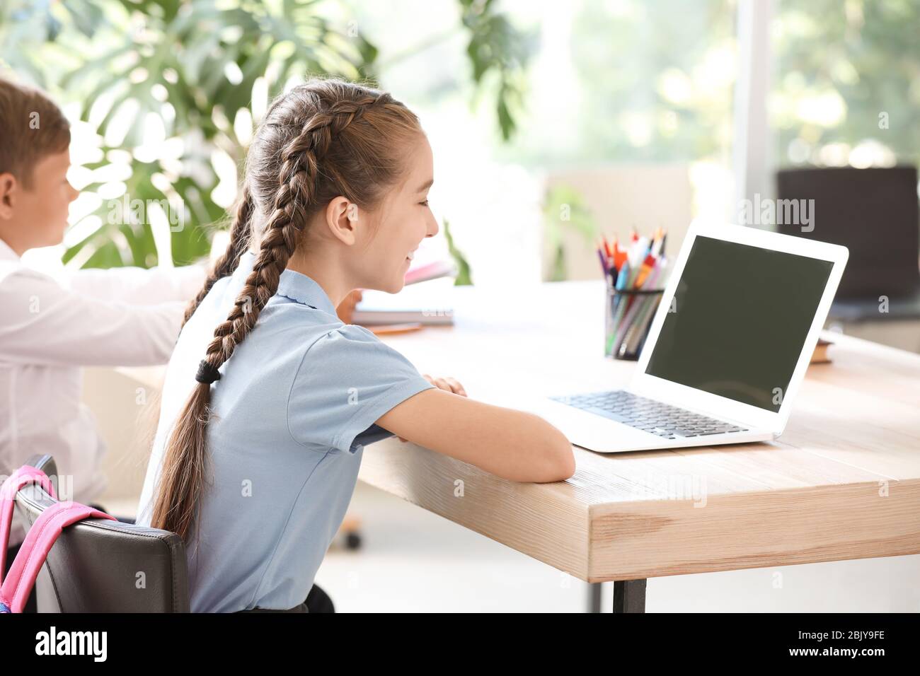 Cute little pupils during lesson in classroom Stock Photo - Alamy
