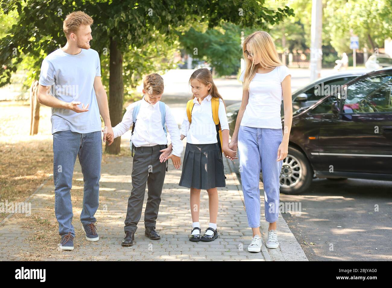 Little children going to school with their parents Stock Photo - Alamy